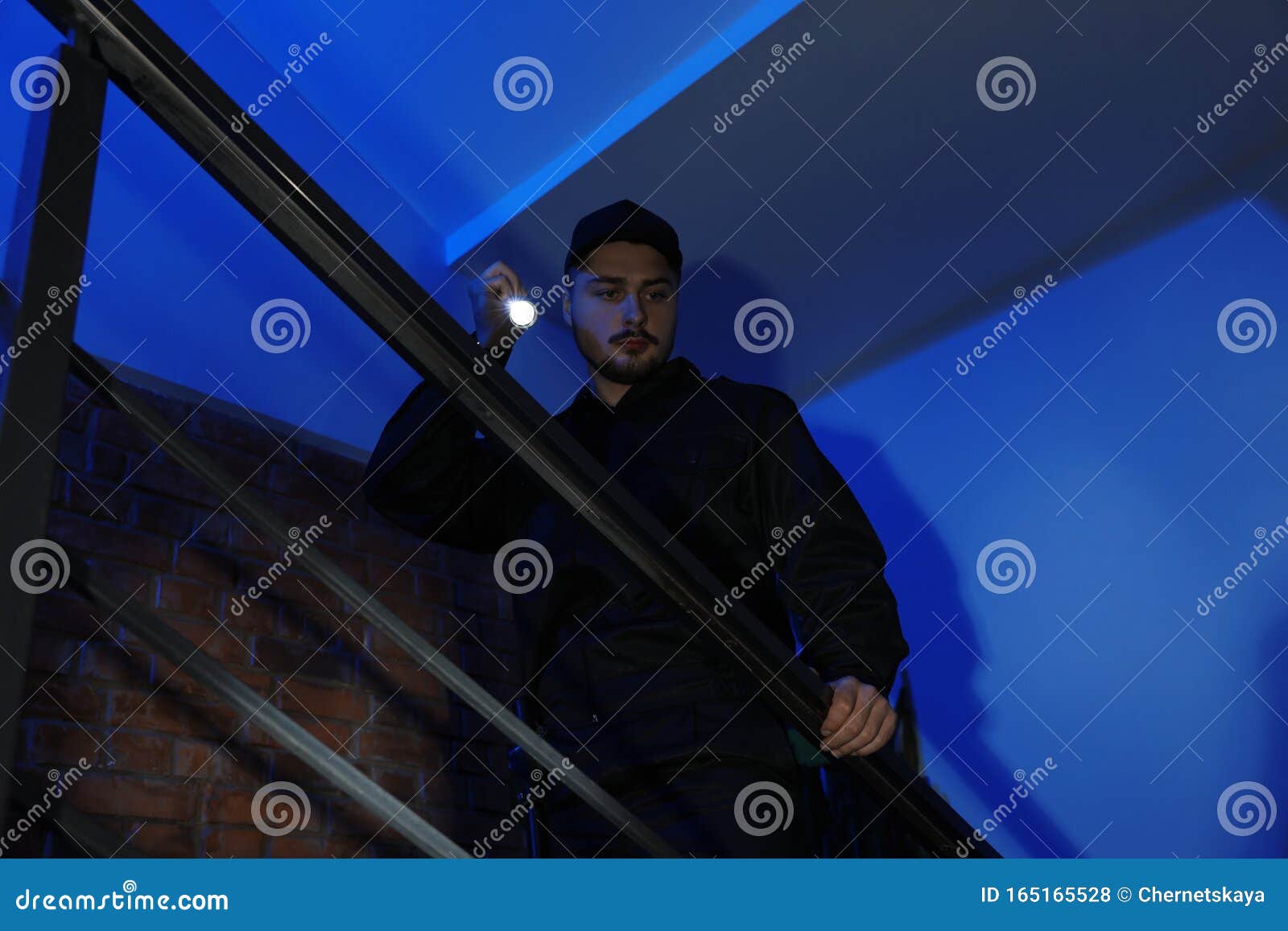 Male Security Guard with Flashlight on Stairs Stock Photo - Image of ...