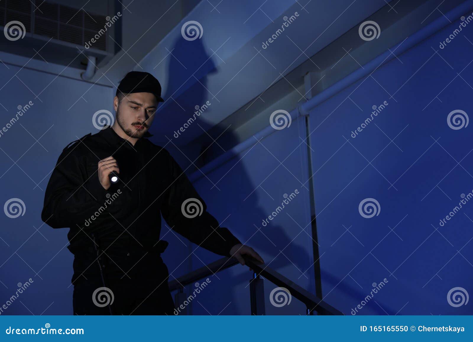 Male Security Guard with Flashlight on Stairs Stock Photo - Image of ...