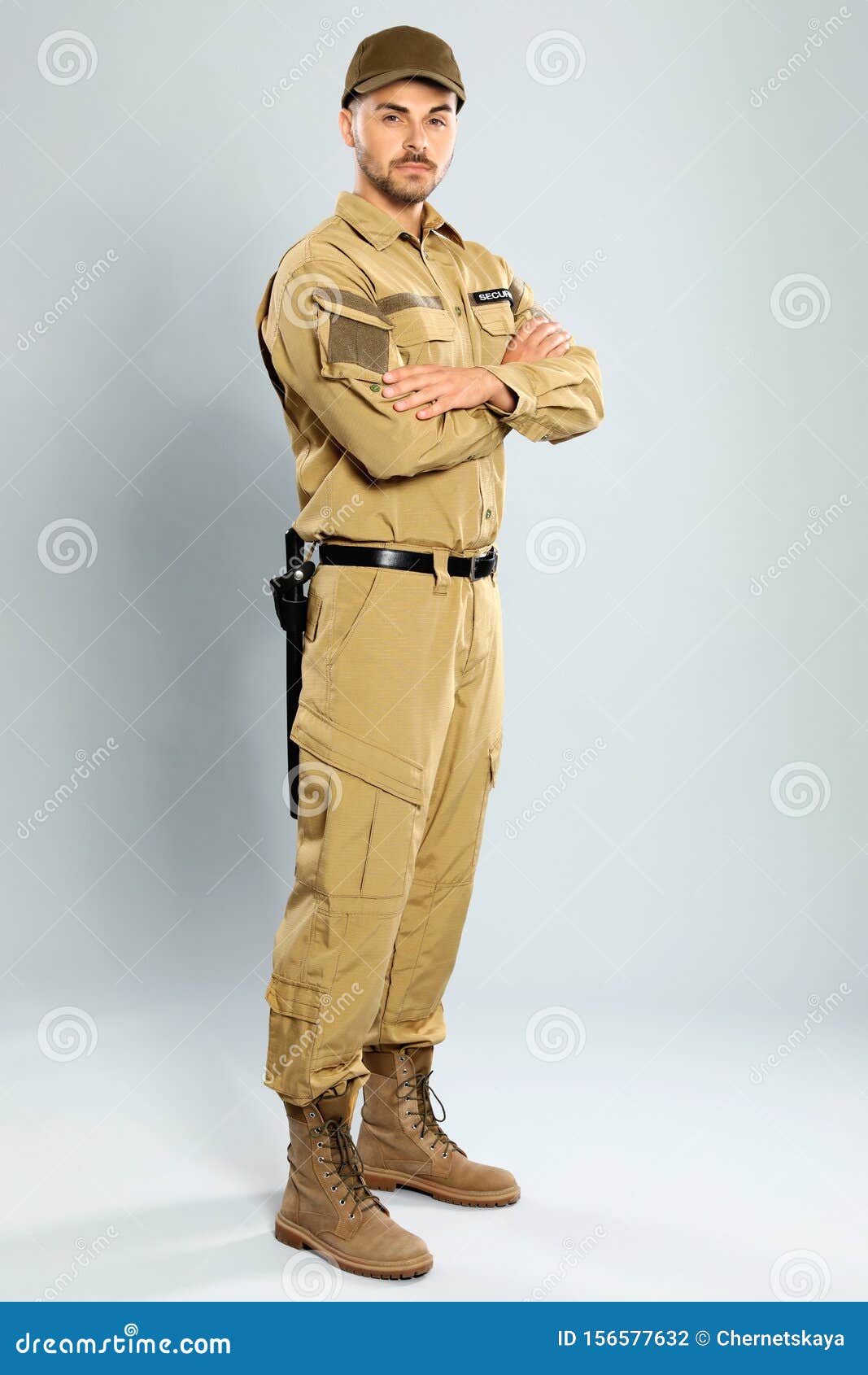 Male Security Guard in Uniform on Grey Stock Photo - Image of crossed ...