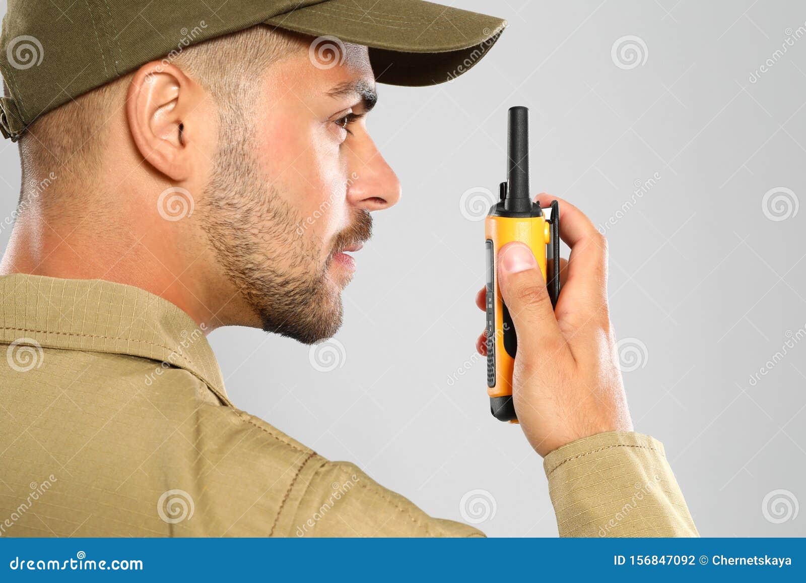 Male Security Guard in Using Portable Radio Transmitter on Grey ...