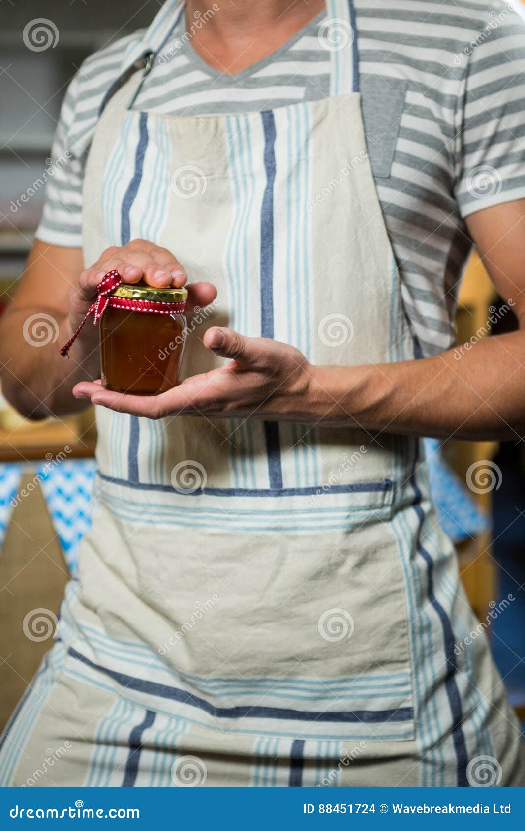 Male Shop Assistant Holding a Jar of Jam Stock Photo - Image of people ...