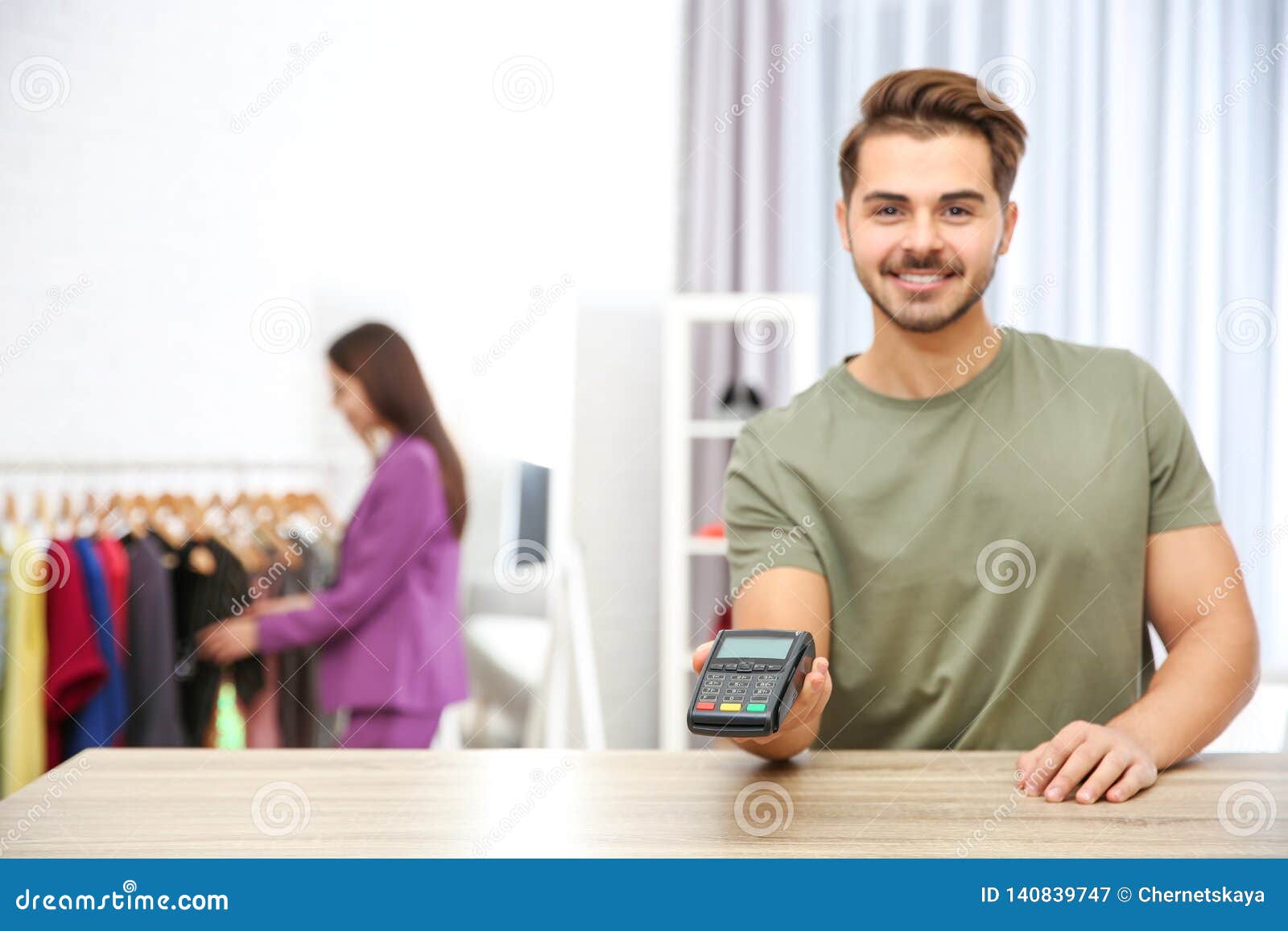 Male Shop Assistant with Payment Terminal at Counter Stock Image ...
