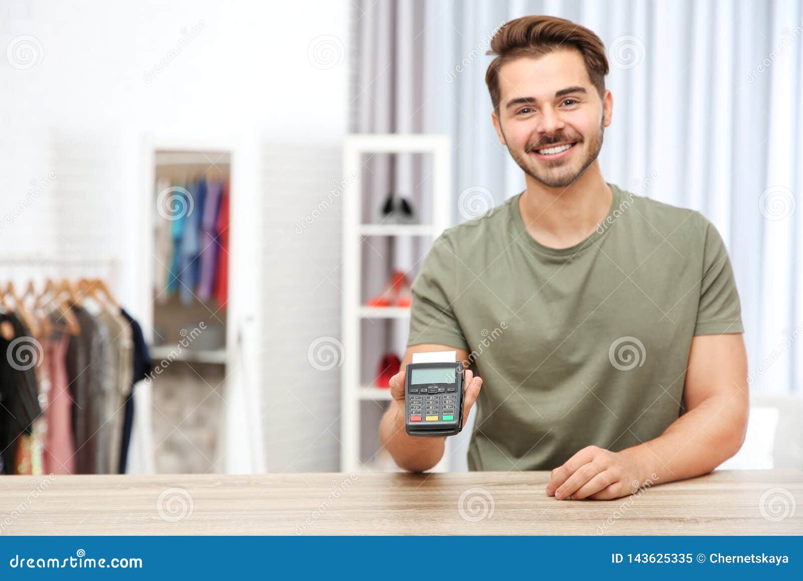 Male Shop Assistant with Payment Terminal at Counter Stock Image ...