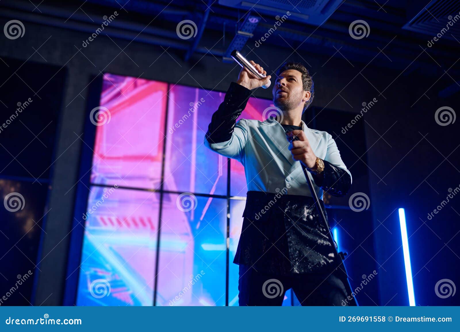 Male Singer Holding Microphone Standing and Performing on Stage Stock ...