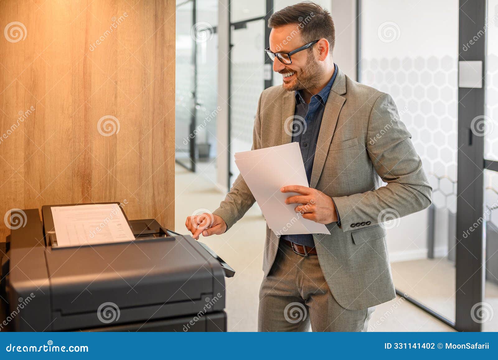 Male Smiling Assistant in Eyeglasses Holding Documents and Operating ...