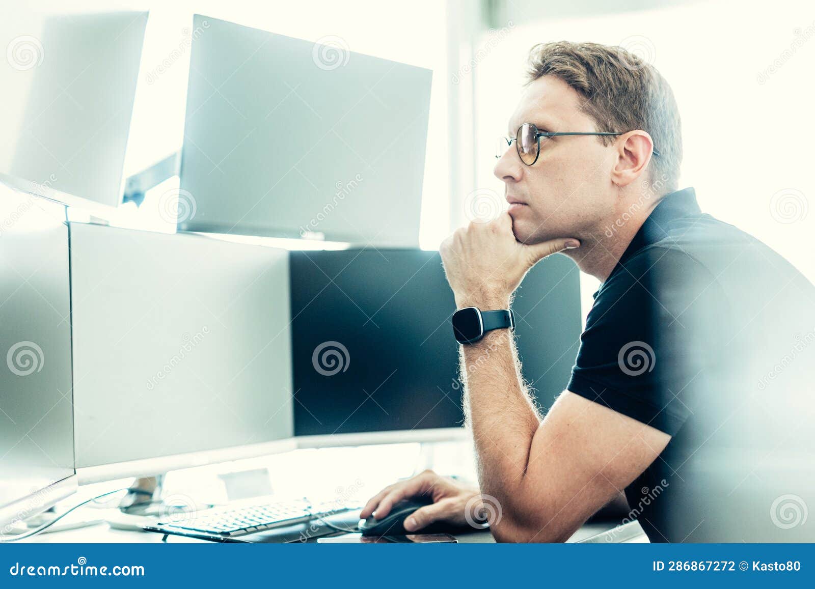 Stock Broker Trading Online Watching Charts and Data Analyses on Multiple Computer Screens ...