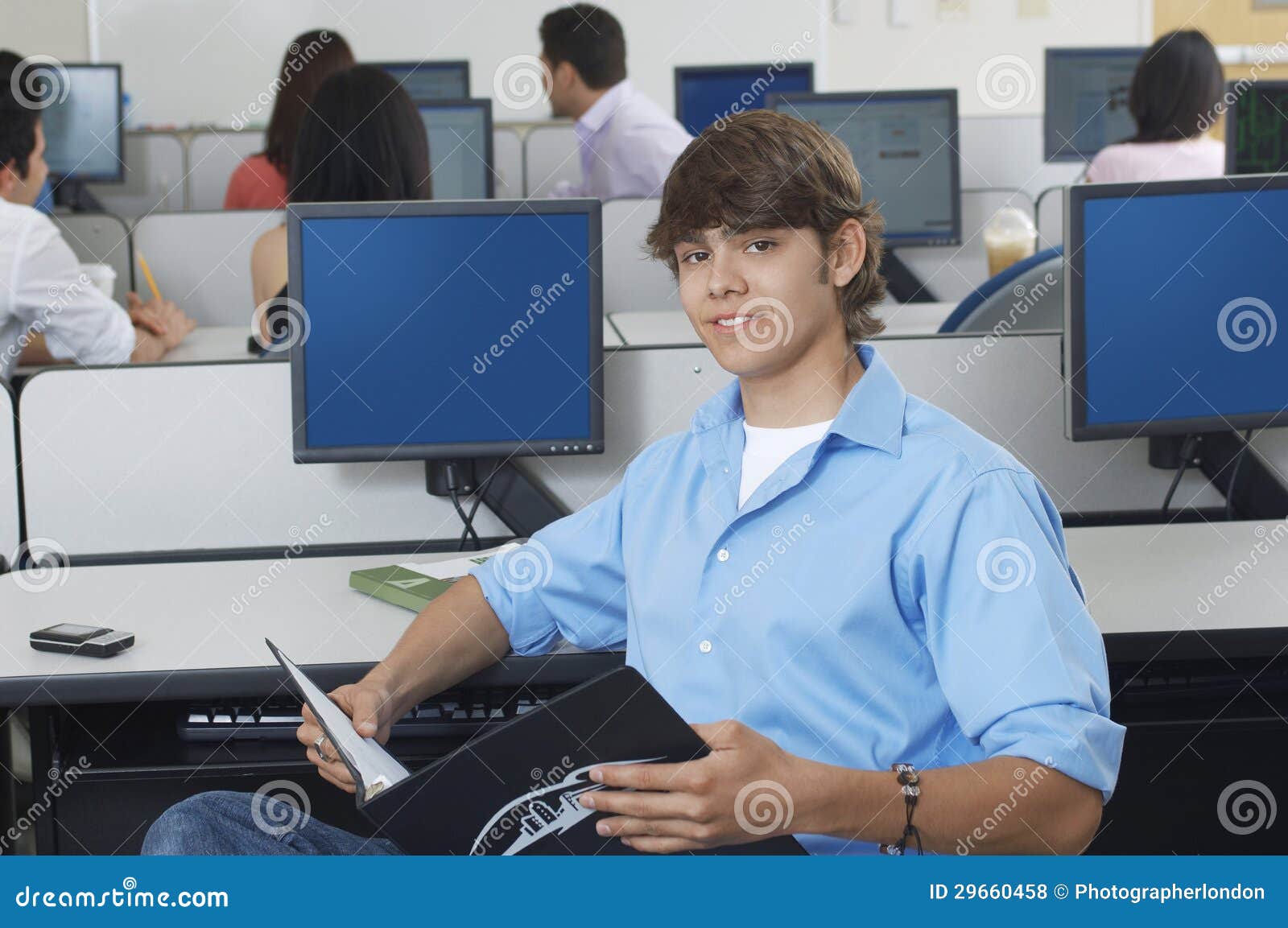 Male Student with Book in Computer Lab Stock Photo - Image of indoors ...