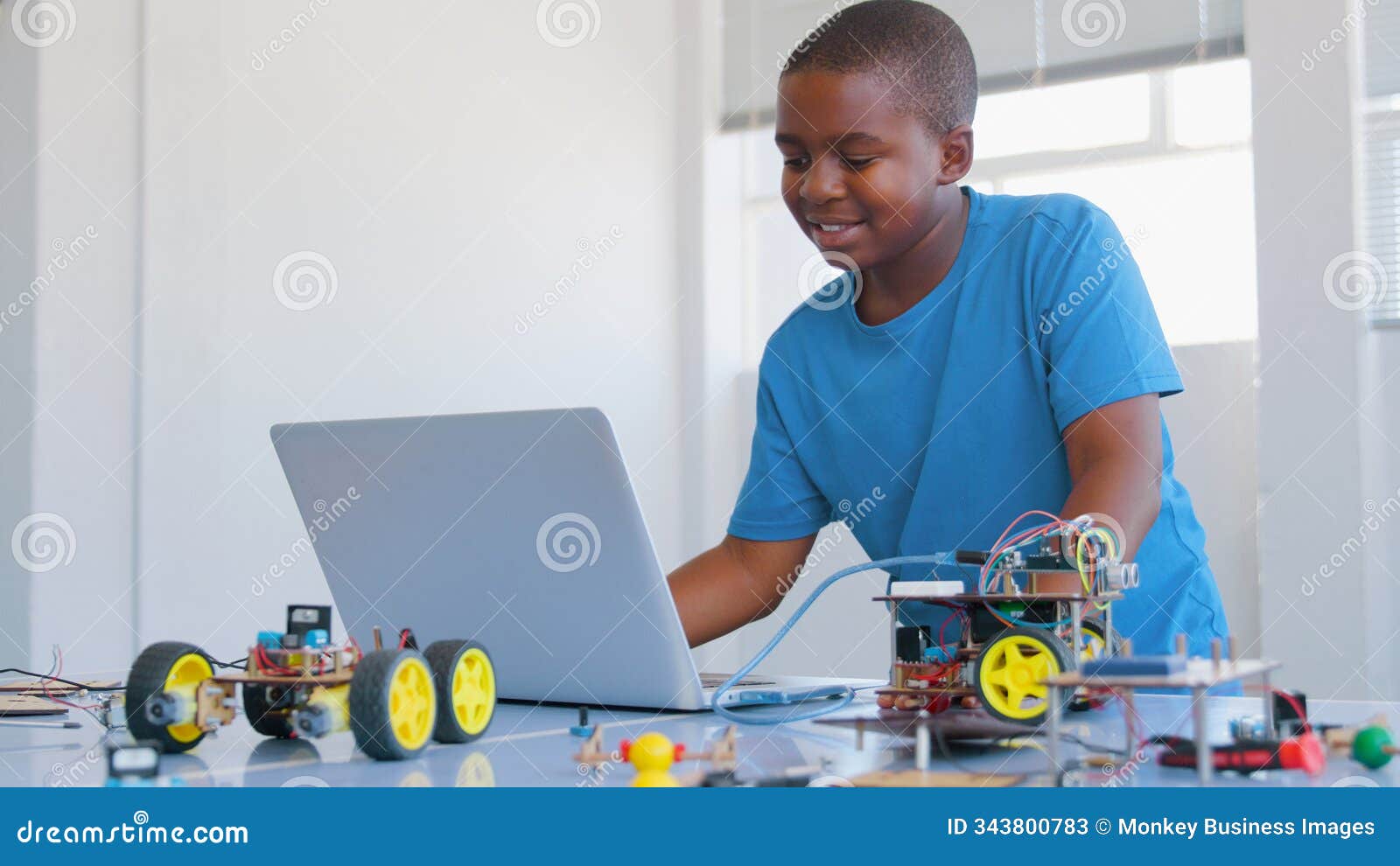 Male Student Building and Programming Robot Vehicle in after School ...