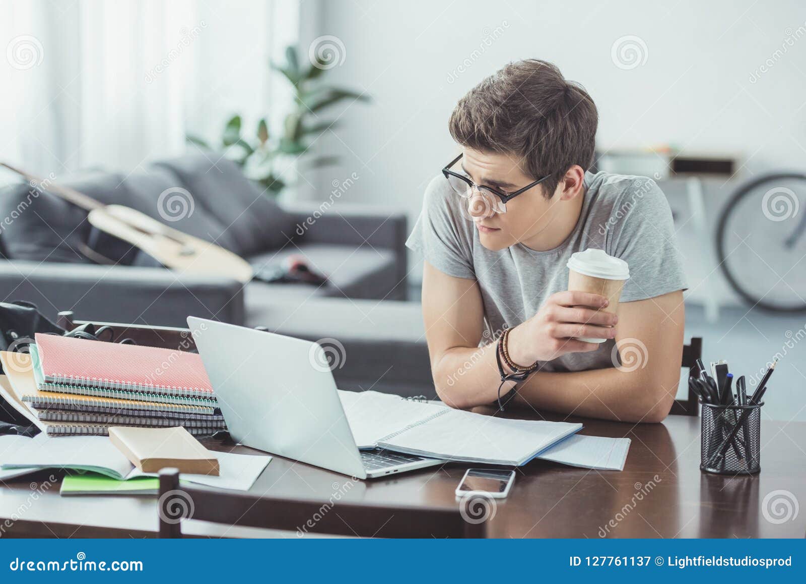 Male Student with Coffee Doing Homework with Laptop Stock Image - Image ...