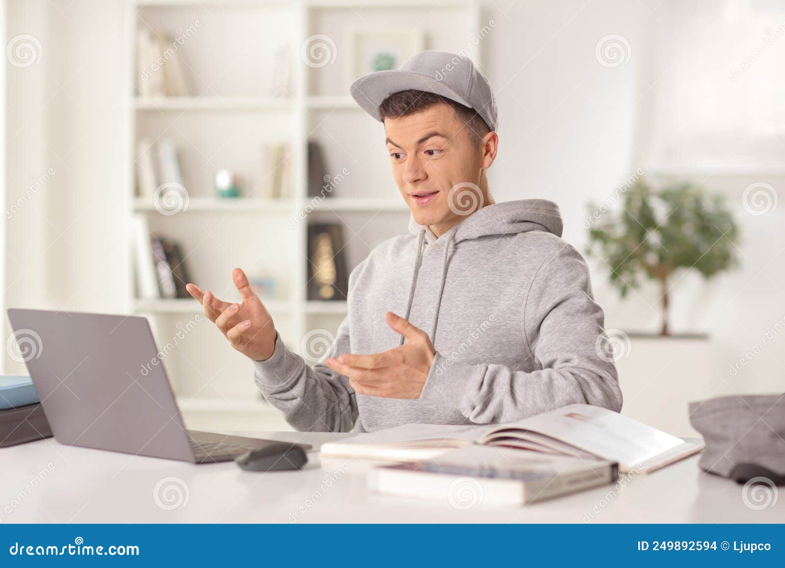 Male Student Explaining in Front of a Laptop Computer Stock Photo ...