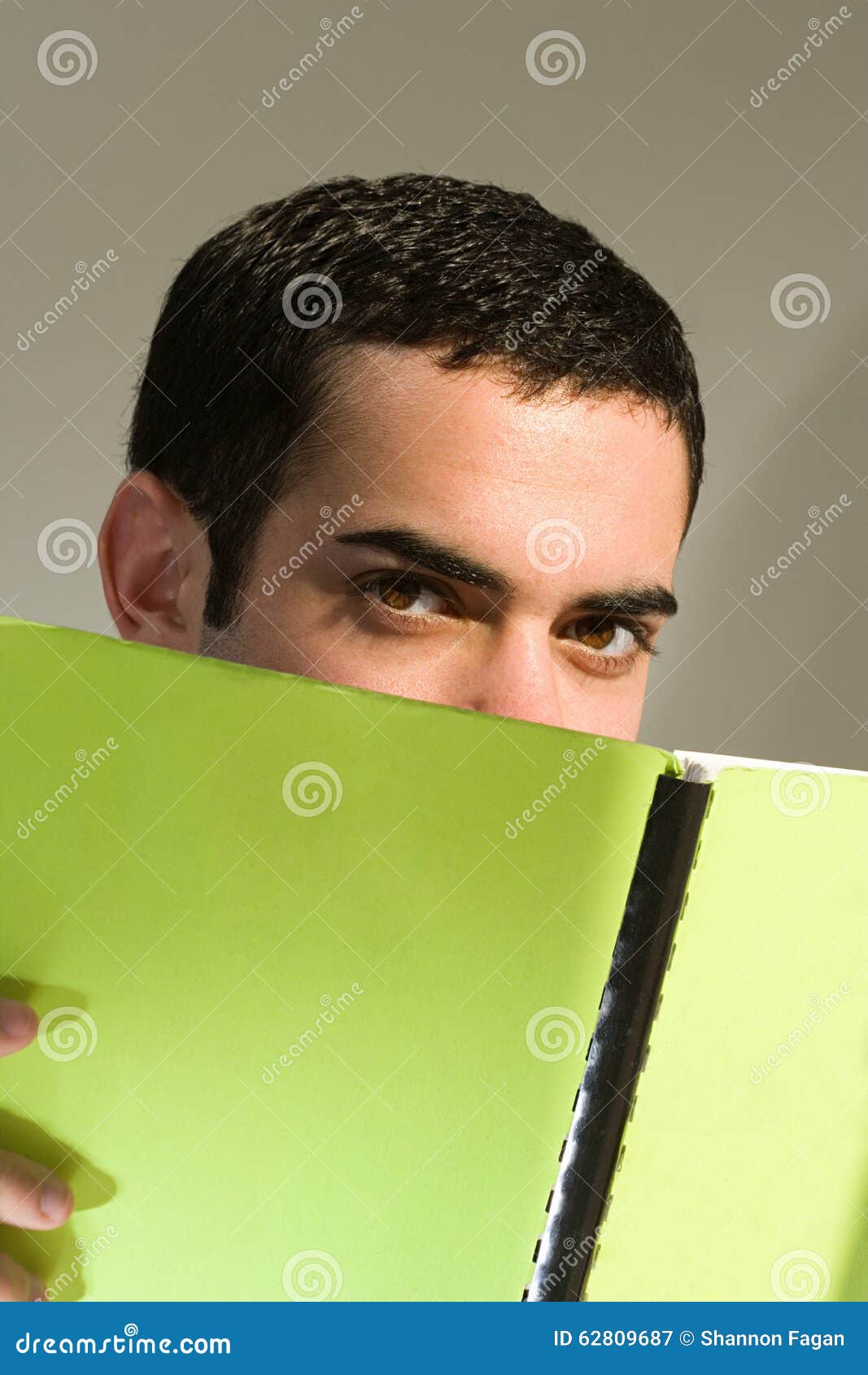 Male Student Hiding Behind a Book Stock Image - Image of people ...