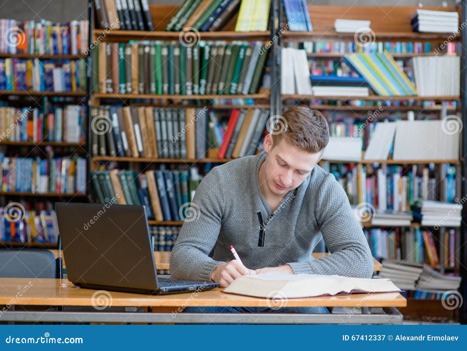 Male Student with Laptop Studying in the University Library Stock Image ...