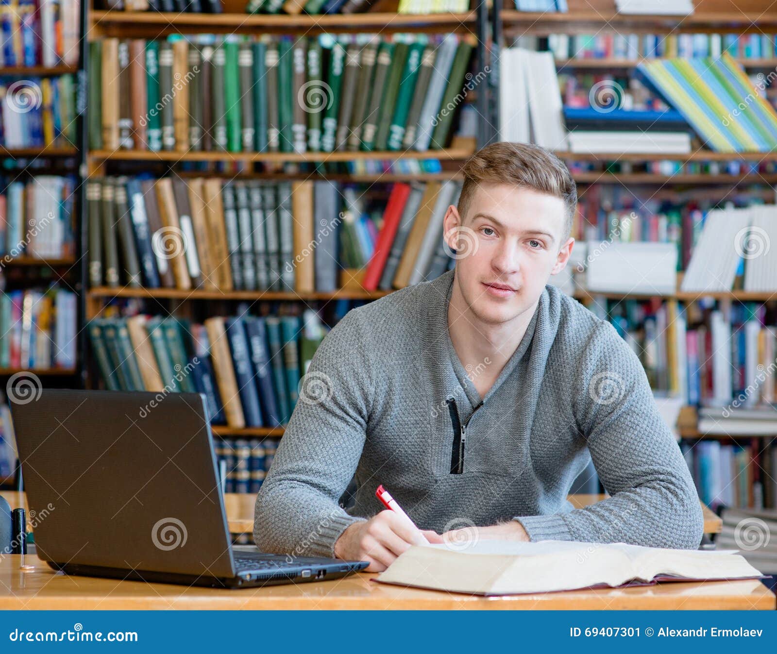Male Student with Laptop Studying in the University Library Stock Image ...