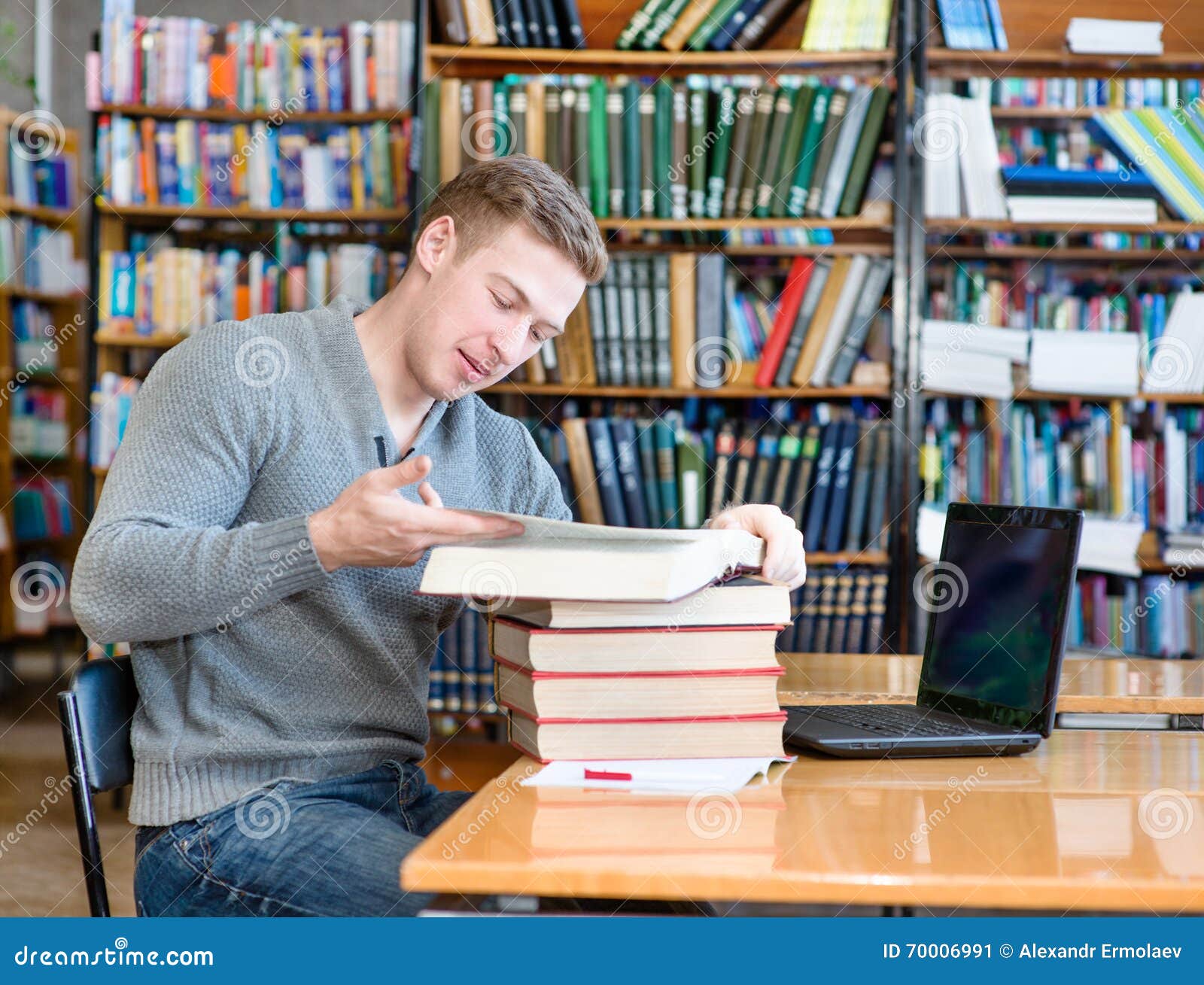 Male Student with Laptop Studying in the University Library Stock Image ...