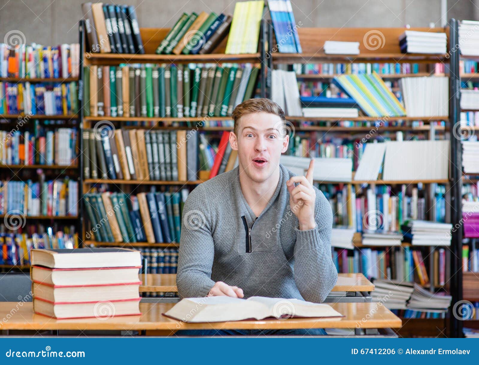 Male Student in a Library Showing Finger Up Stock Photo - Image of ...