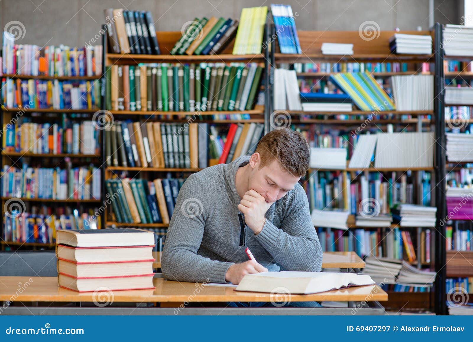 Male Student with Open Book Working in a Library Stock Image - Image of ...