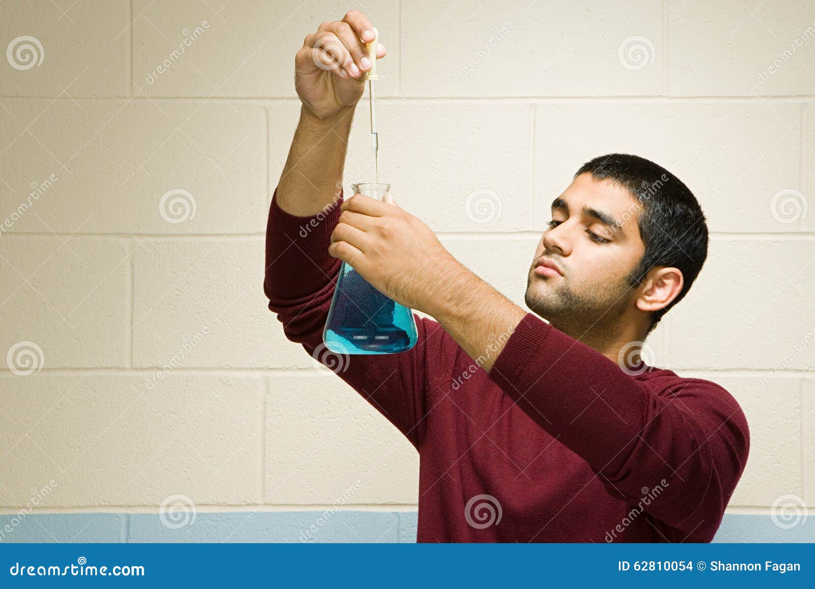 Male Student Performing an Experiment Stock Photo - Image of excitement ...