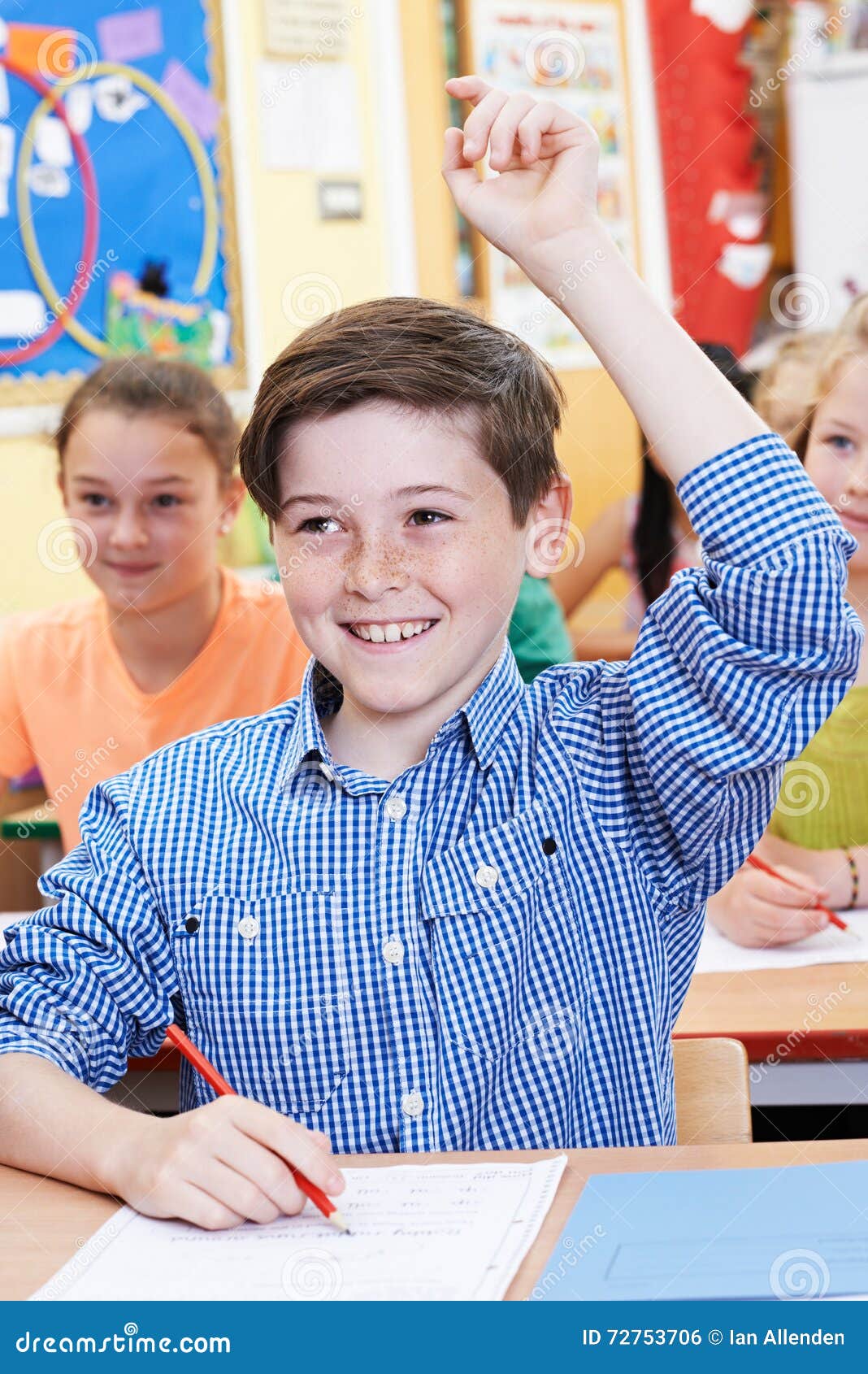 Male Student Raising Hand To Answer Question on Class Stock Photo ...