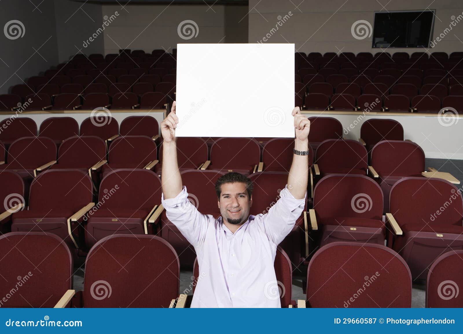Male Student Raising Sign Board while Sitting in Classroom Stock Image ...