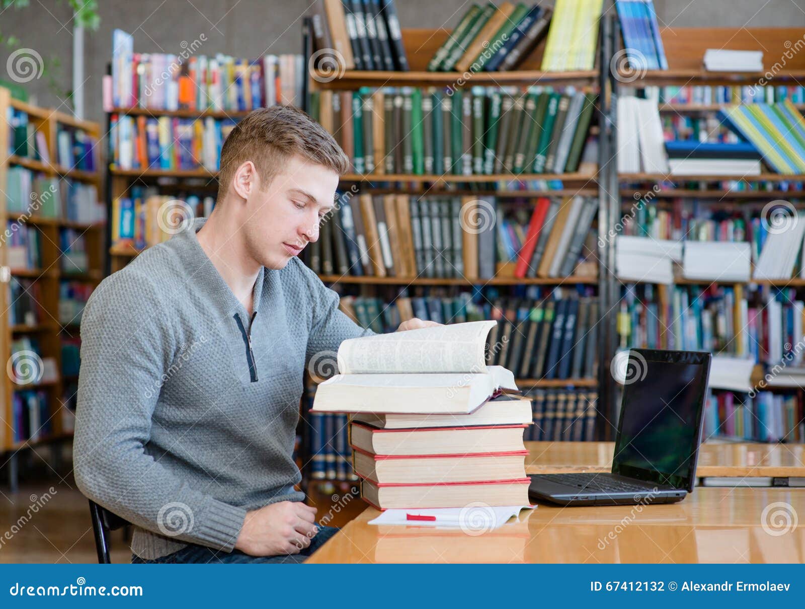 Male Student Reading Book in Library Stock Photo - Image of homework ...