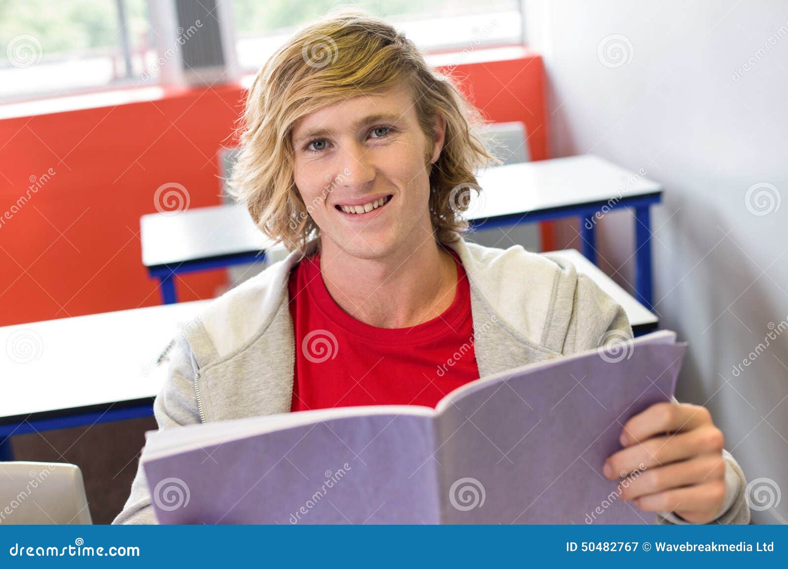 Male Student Reading Notes in Classroom Stock Image - Image of ...