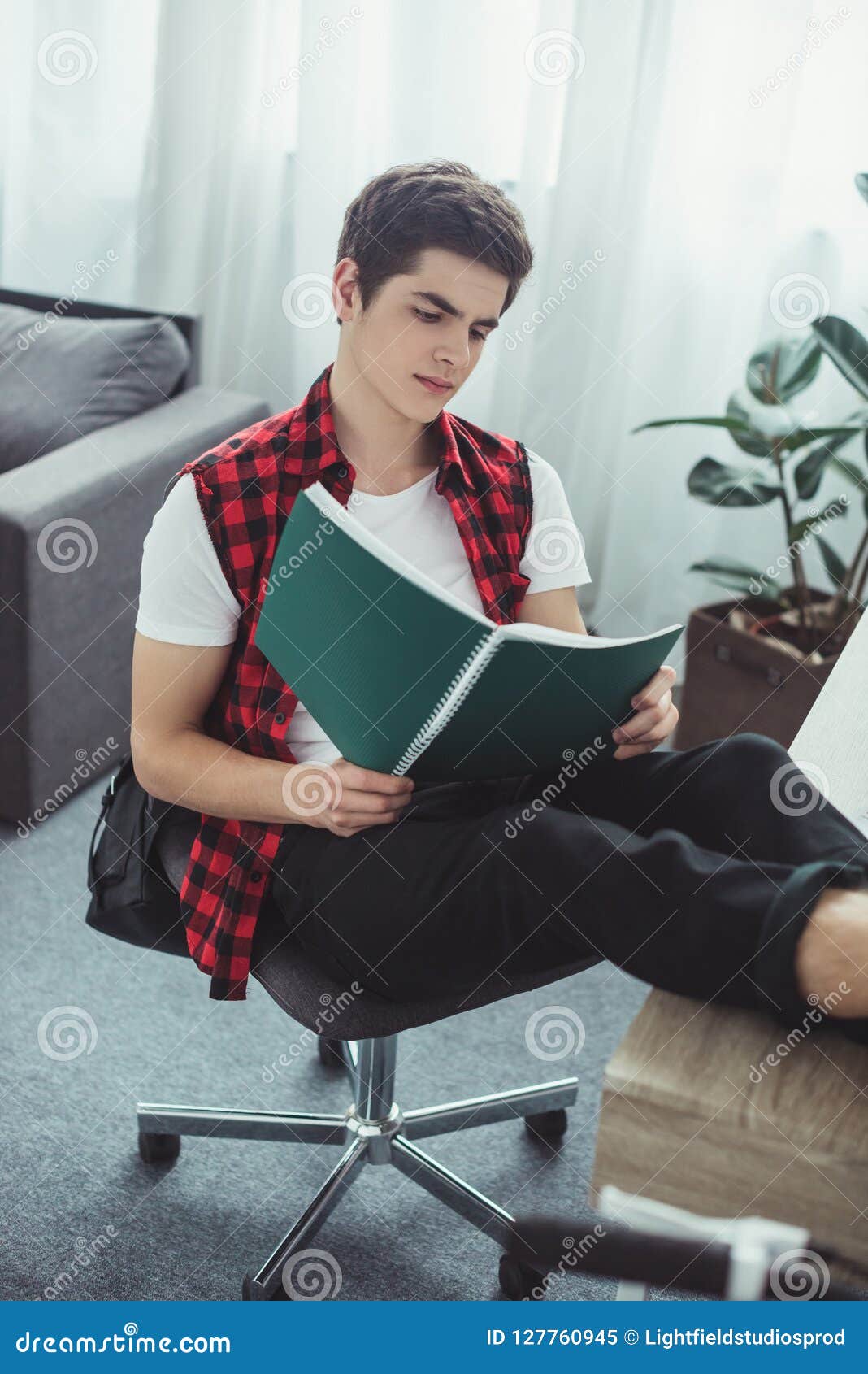 Male Student Reading Textbook at Table Stock Image - Image of handsome ...