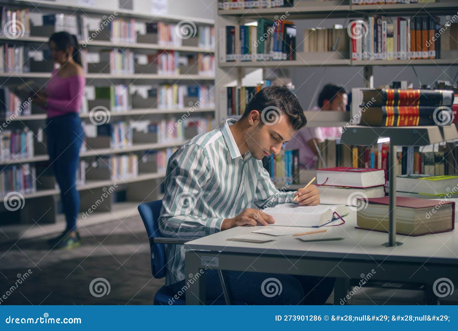 Male Student Studying in Library Stock Photo - Image of library, table ...