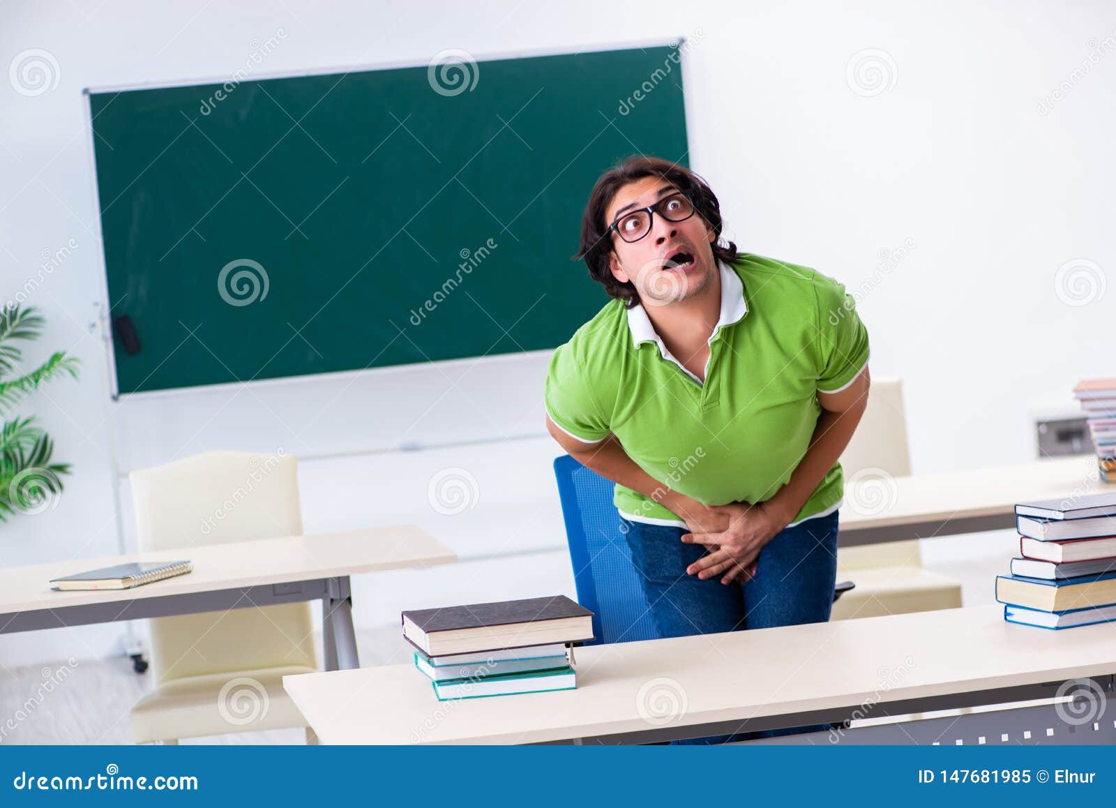 The Male Student Suffering from Urge in the Classroom Stock Image ...