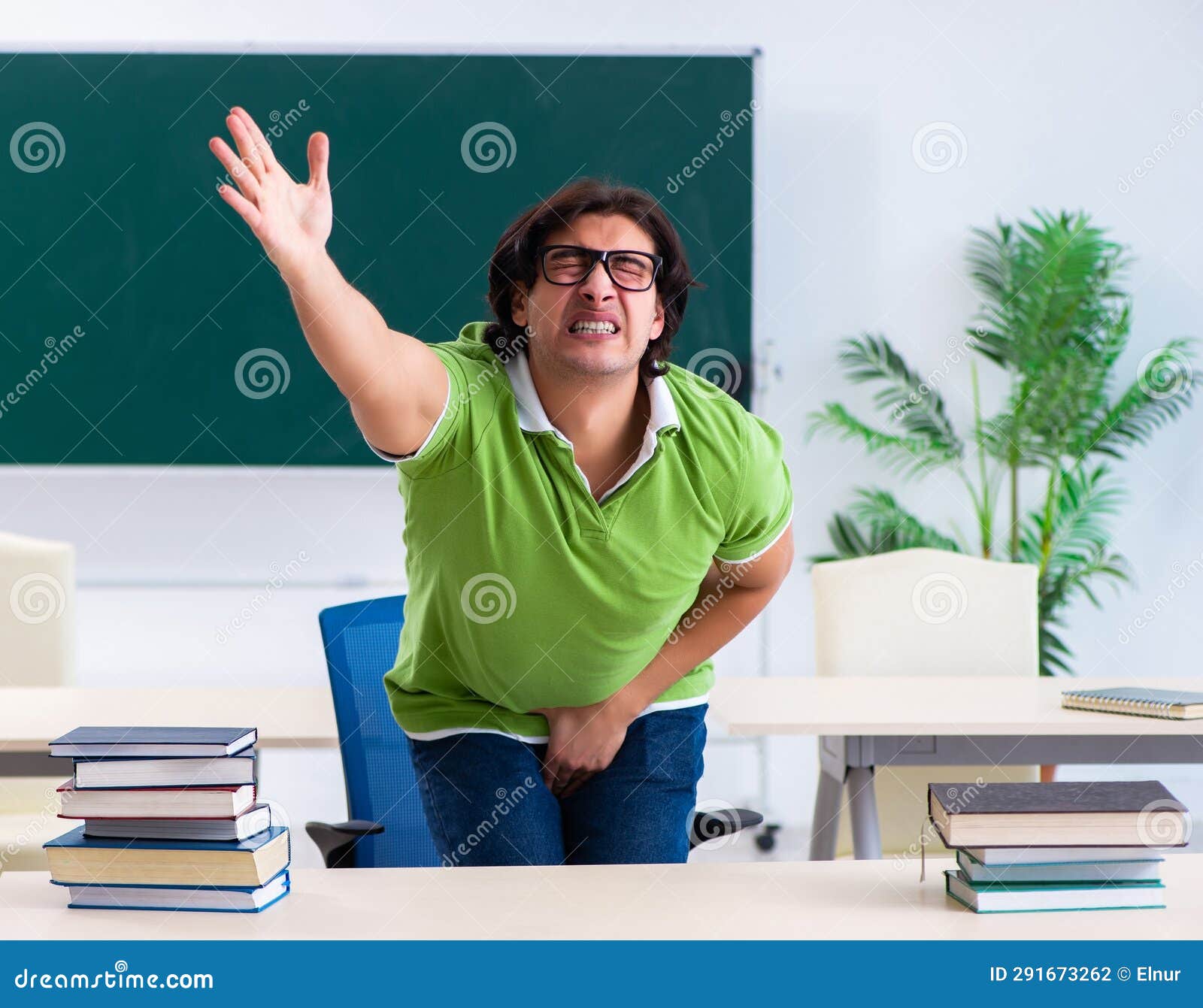 Male Student Suffering from Urge in the Classroom Stock Photo - Image ...