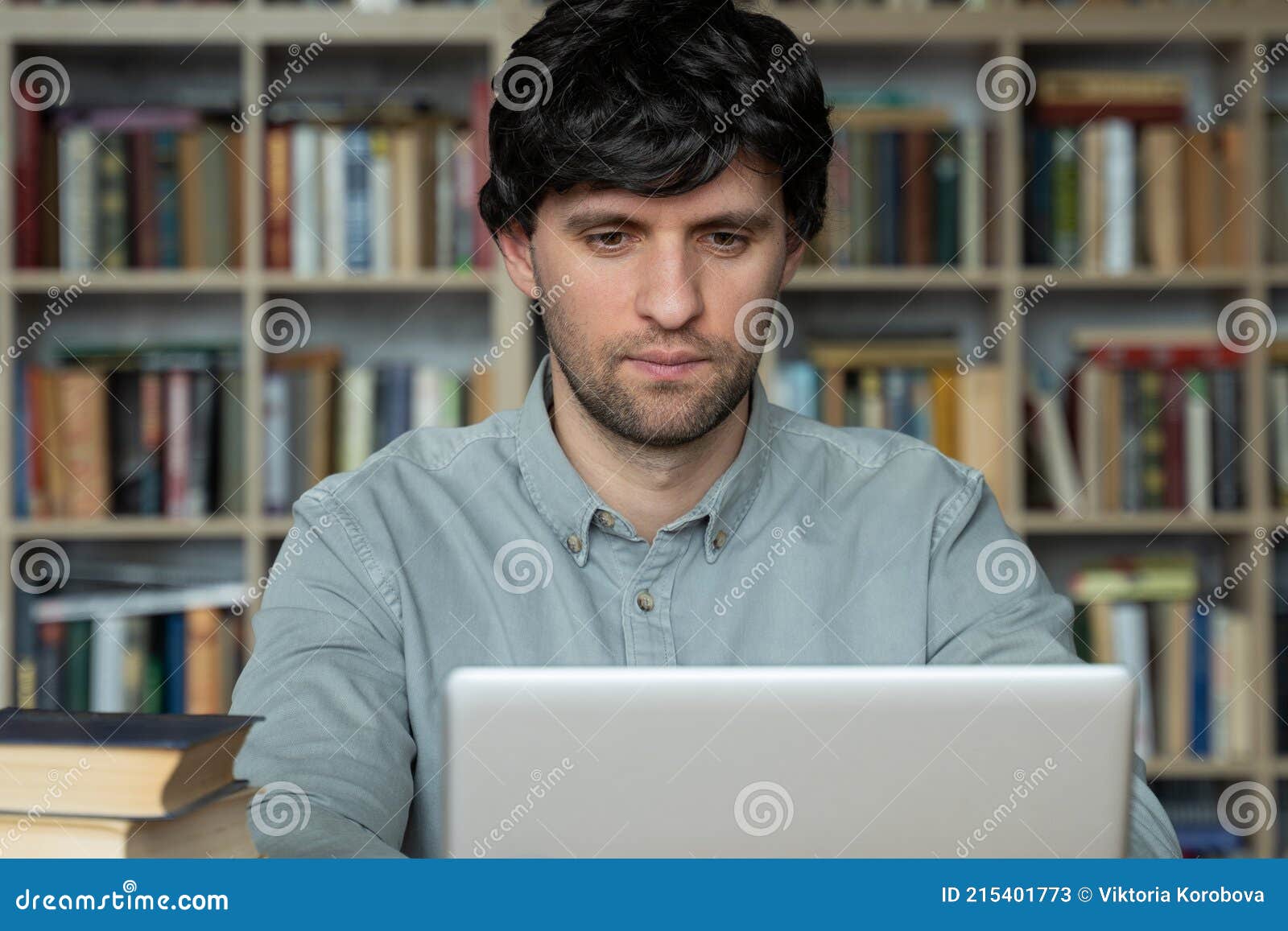 Male Student Using Laptop Studying in the University Library Stock ...