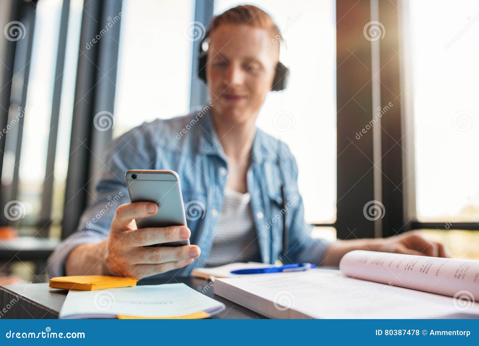 Male Student Using Mobile Phone in a Library Stock Photo - Image of ...