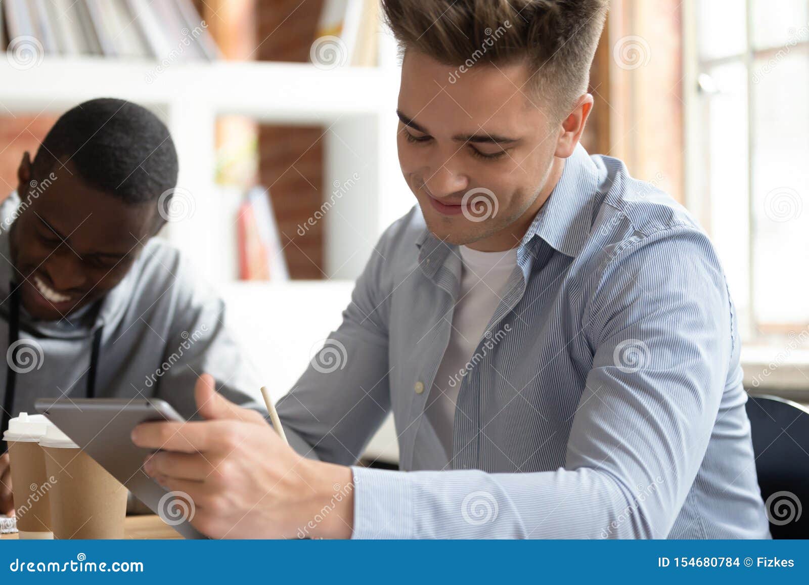 Male Student Using Tablet Making Notes Preparing for Test Stock Photo ...