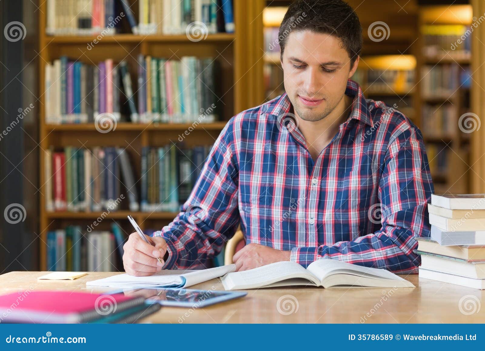Male Student Writing Notes at Desk in the Library Stock Image - Image ...