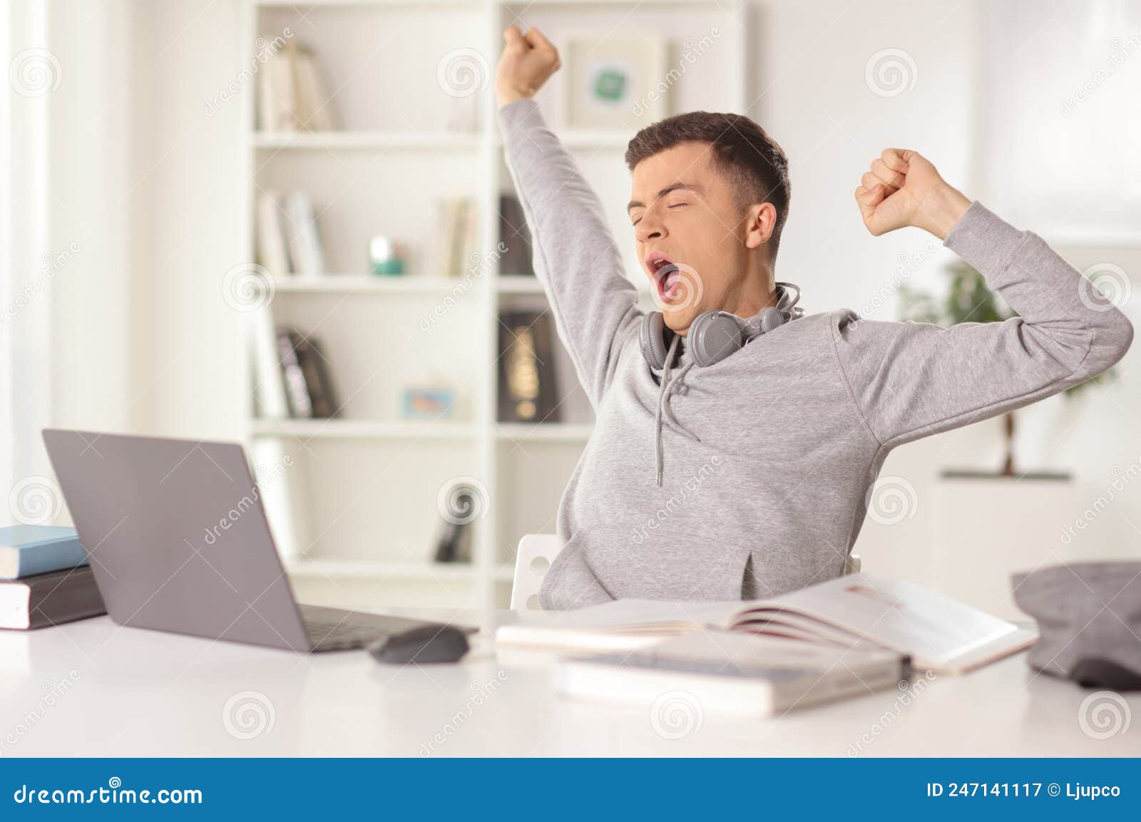 Male Student Yawning during Online Class in Front of a Laptop Computer ...