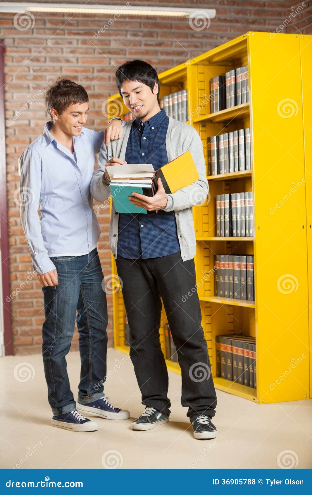 Male Students Looking at Book in College Library Stock Photo - Image of ...