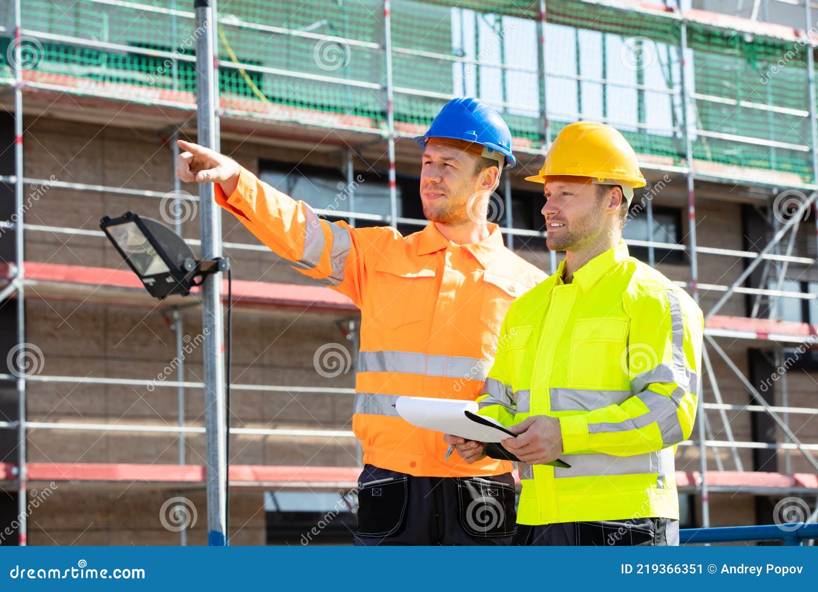 Supervisor Looking at Architect Writing on Clipboard Stock Image ...