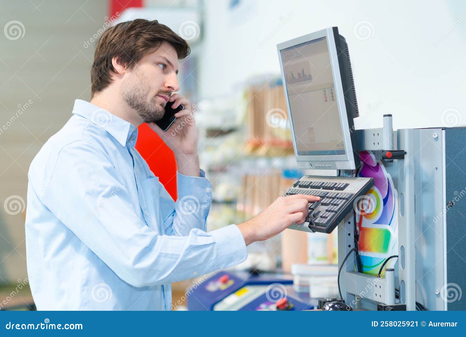 Male Supervisor Looking at Clipboard while Talking on Mobile Phone ...