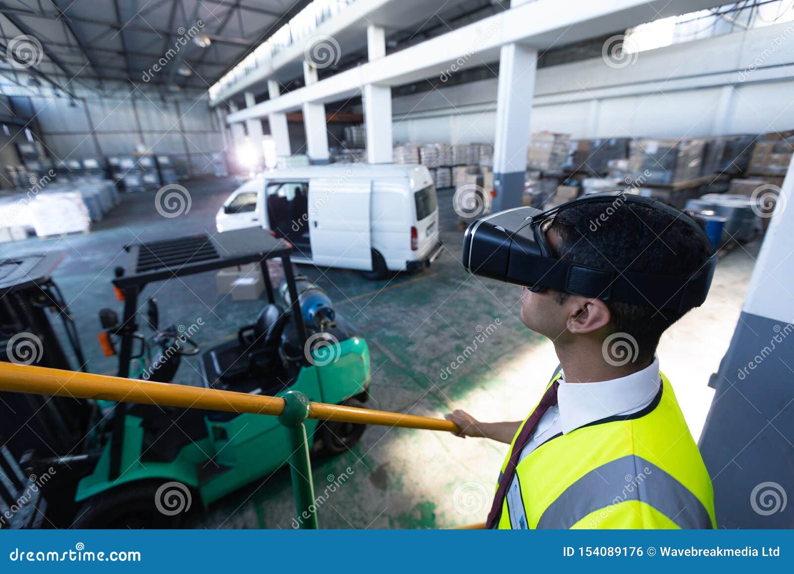 Male Supervisor Using Virtual Reality Headset in Warehouse Stock Photo ...
