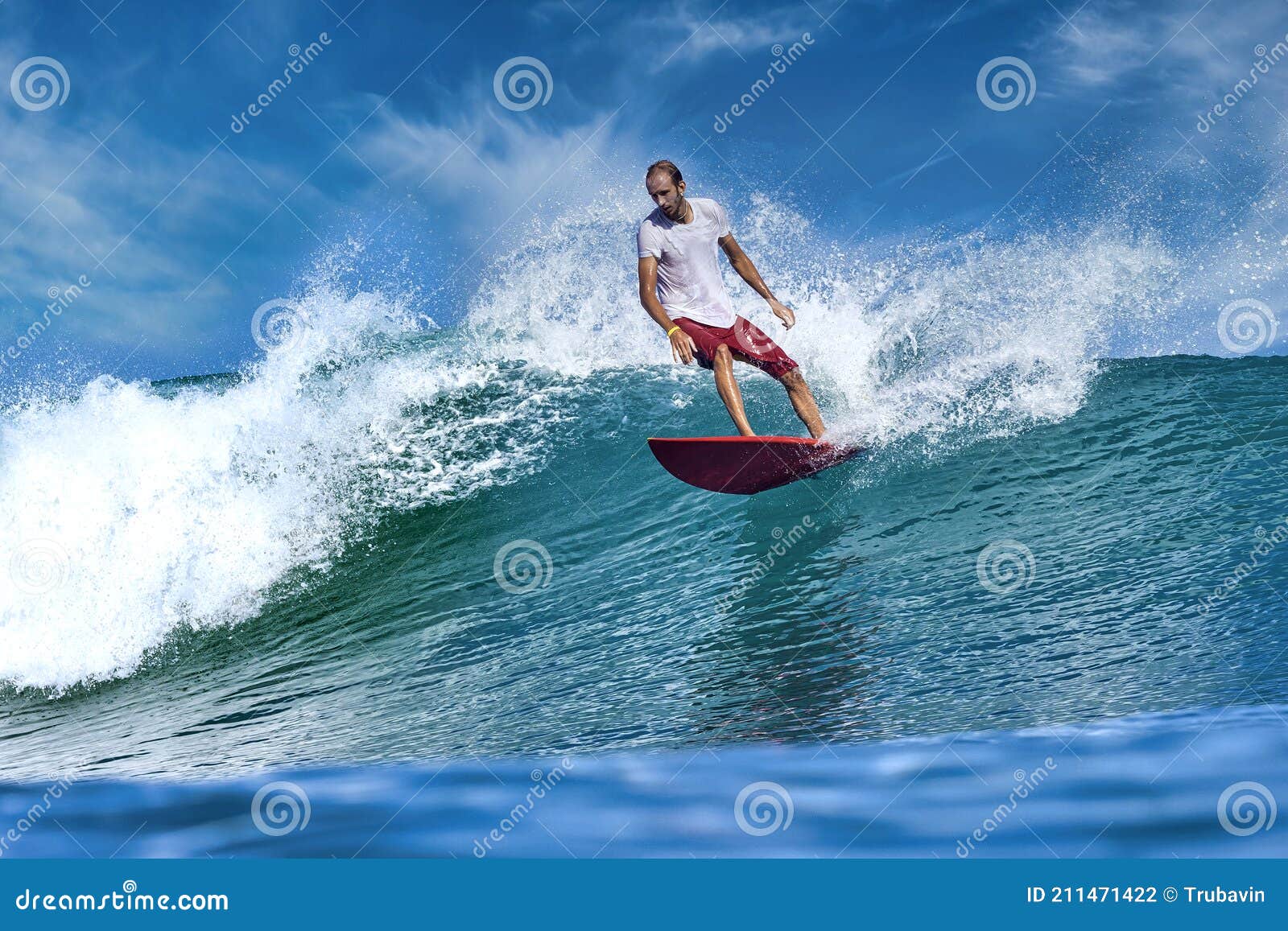 Male surfer on a blue wave stock photo. Image of freedom - 211471422