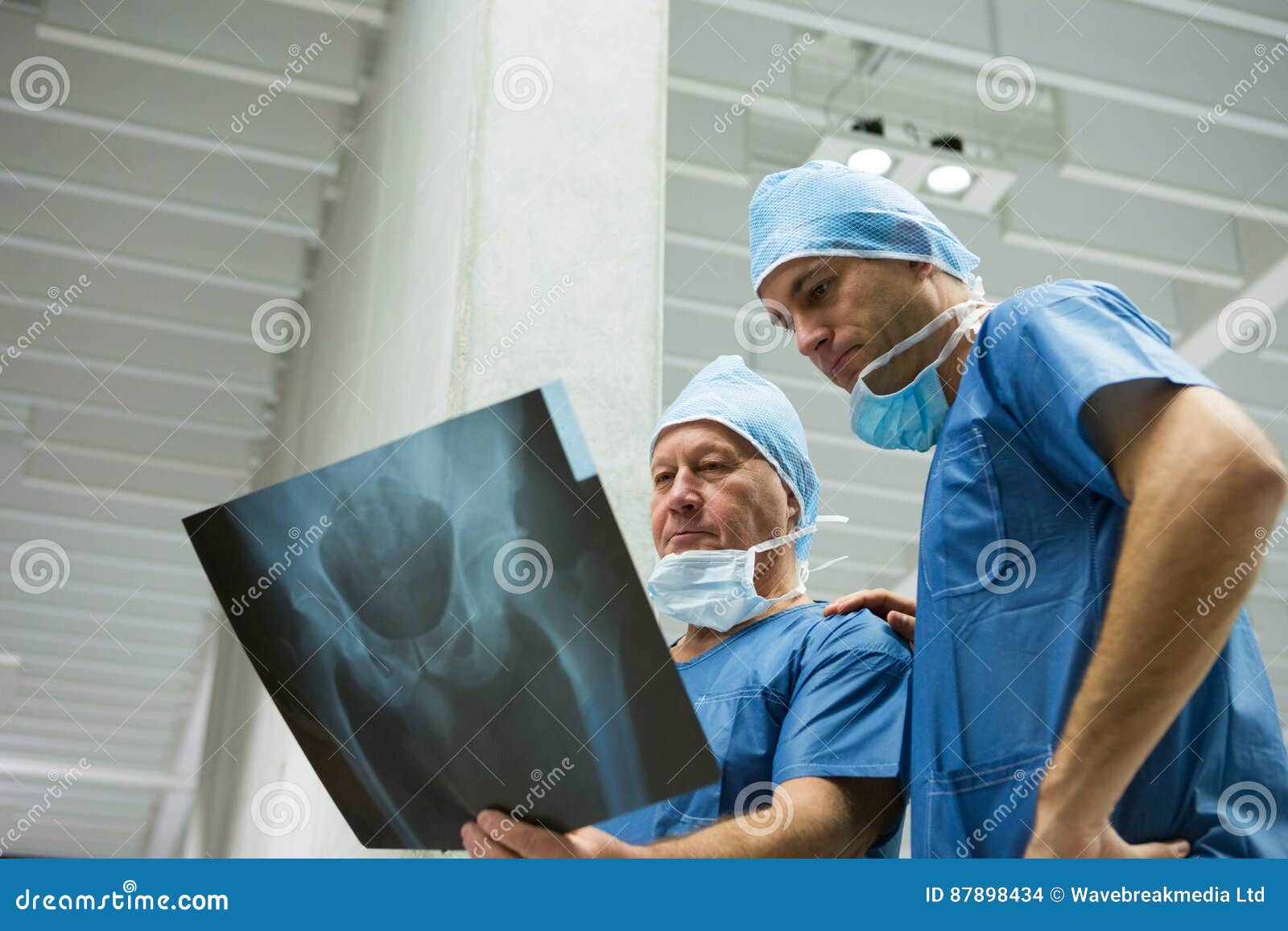Male Surgeons Examining X-ray Stock Photo - Image of hospital ...