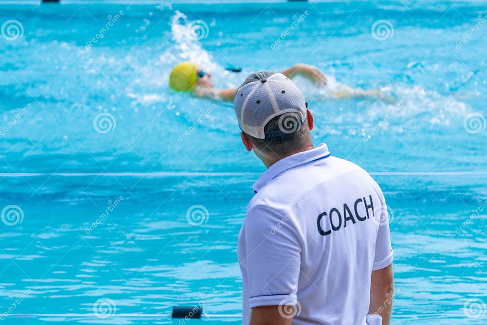 Male Swimming Coach Watching His Swimmer Practice Editorial Stock Image