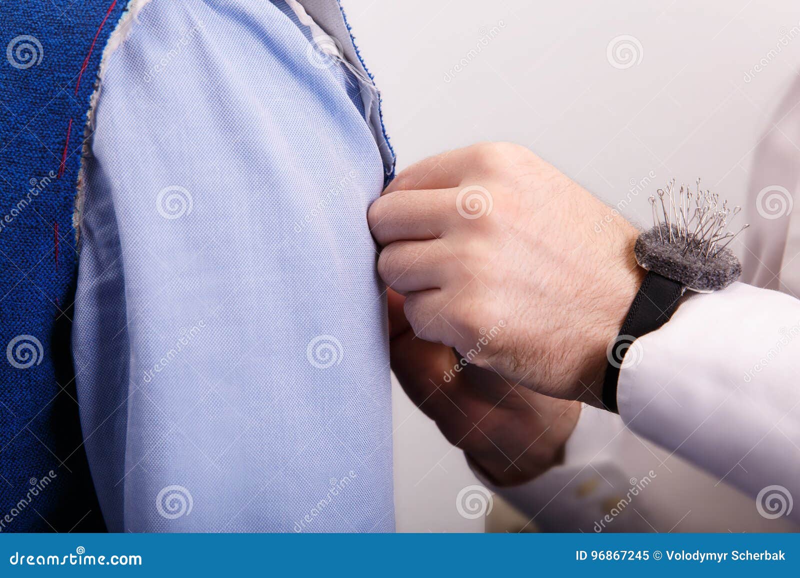 Male Tailor Designer Make Marks on a Jacket during Bespoke Suit Fitting ...
