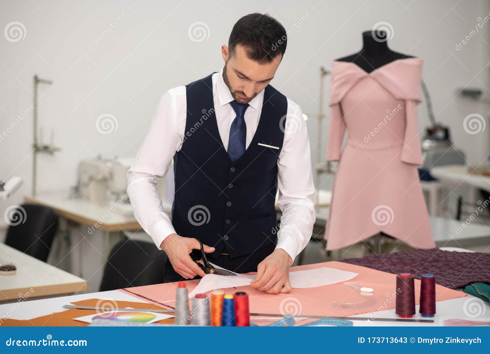 Male Tailor Standing and Cutting Out Paper Pattern Stock Image - Image ...