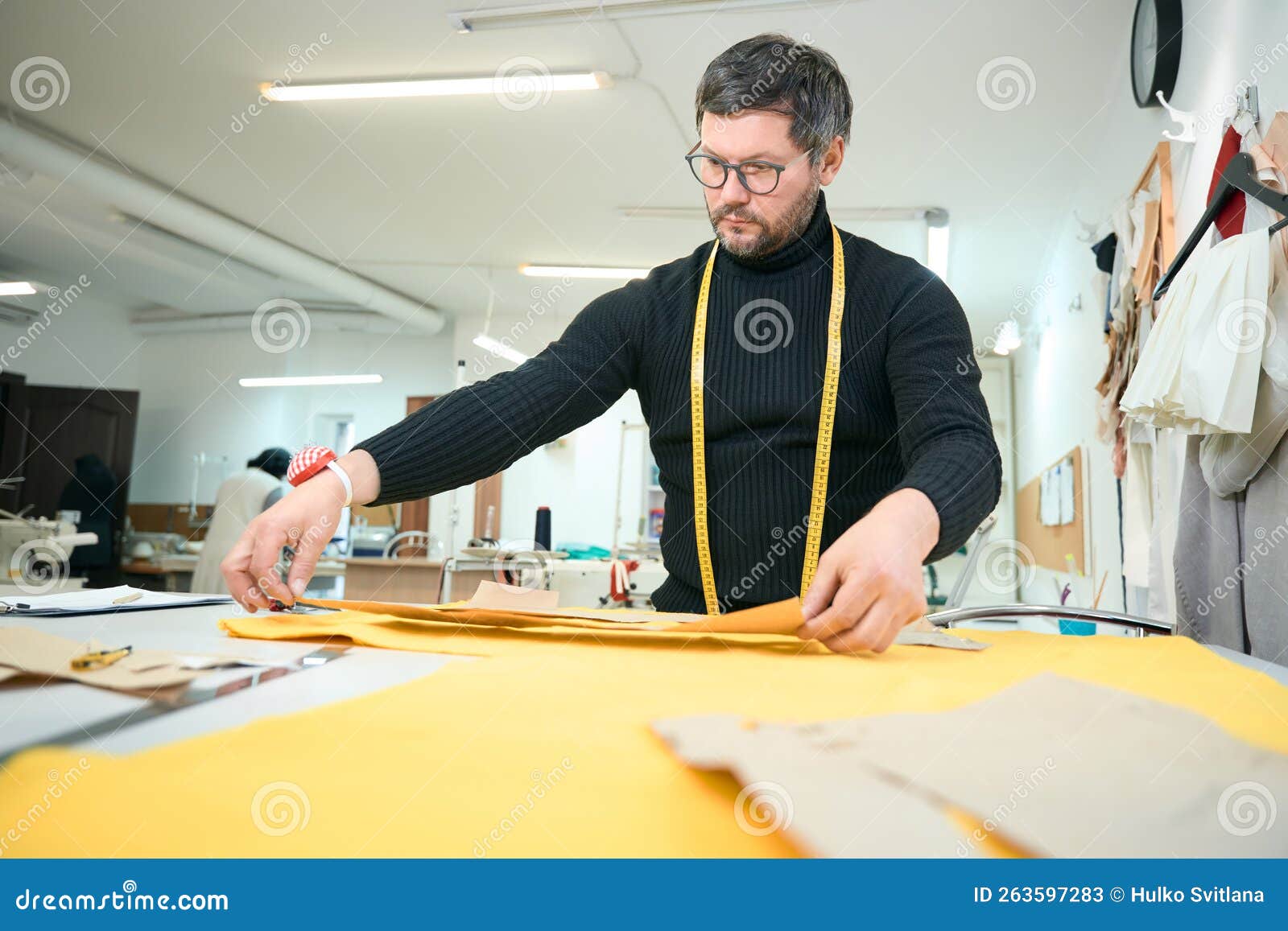 Male Tailor Stands at Cutting Table and Works with Patterns Stock Image ...