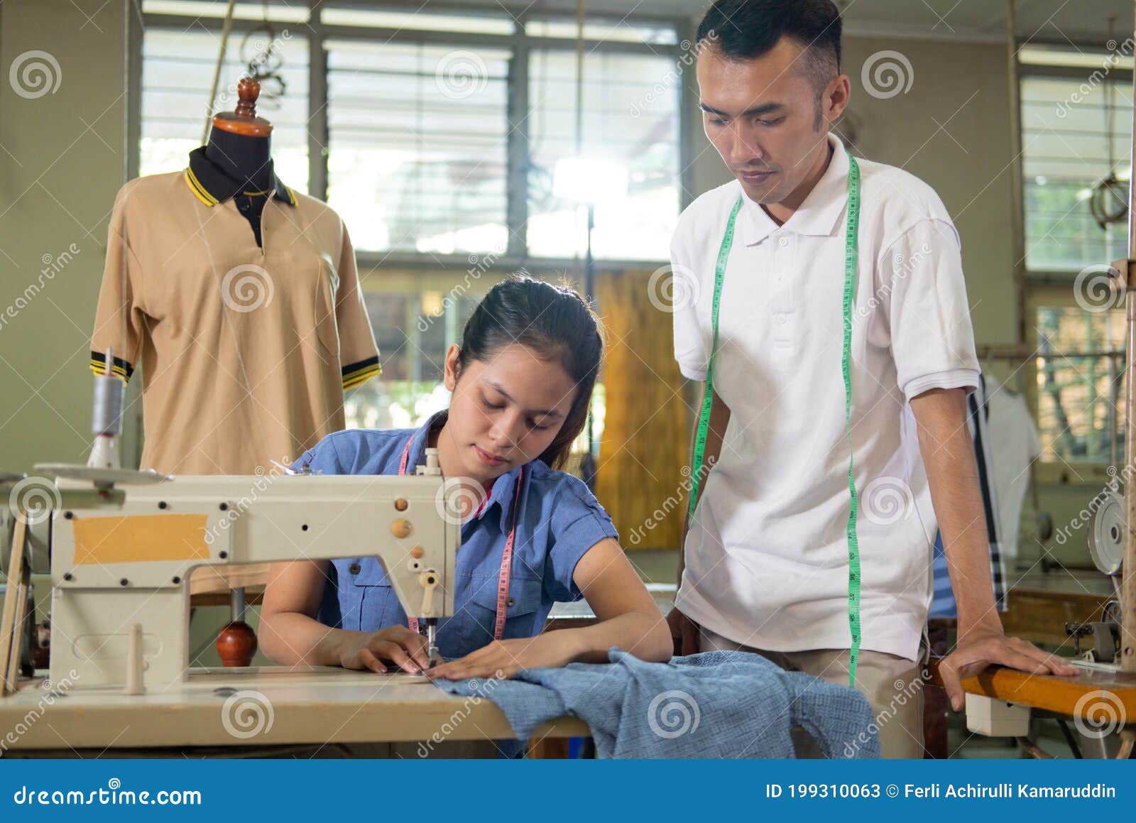 Male Tailor Stands beside and Sees the Female Tailor Using the Sewing ...