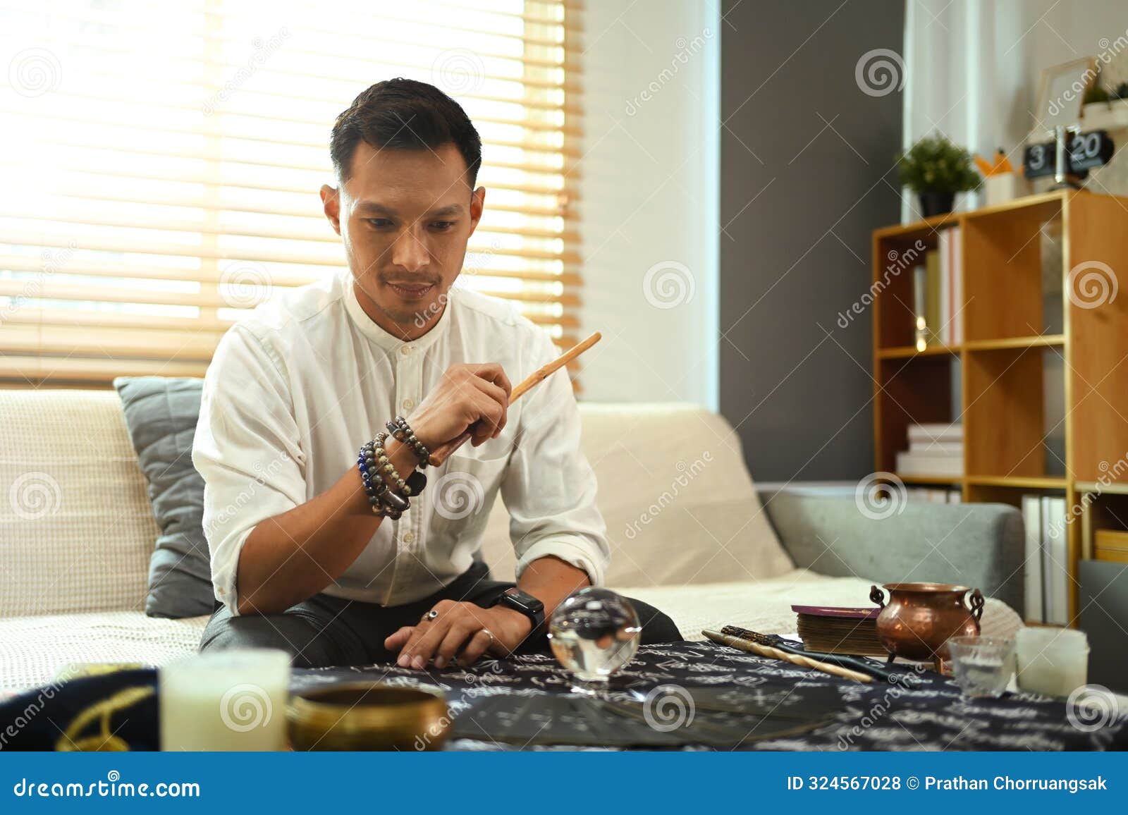Male Tarot Reader Making Predictions at Table Surrounded by Various ...