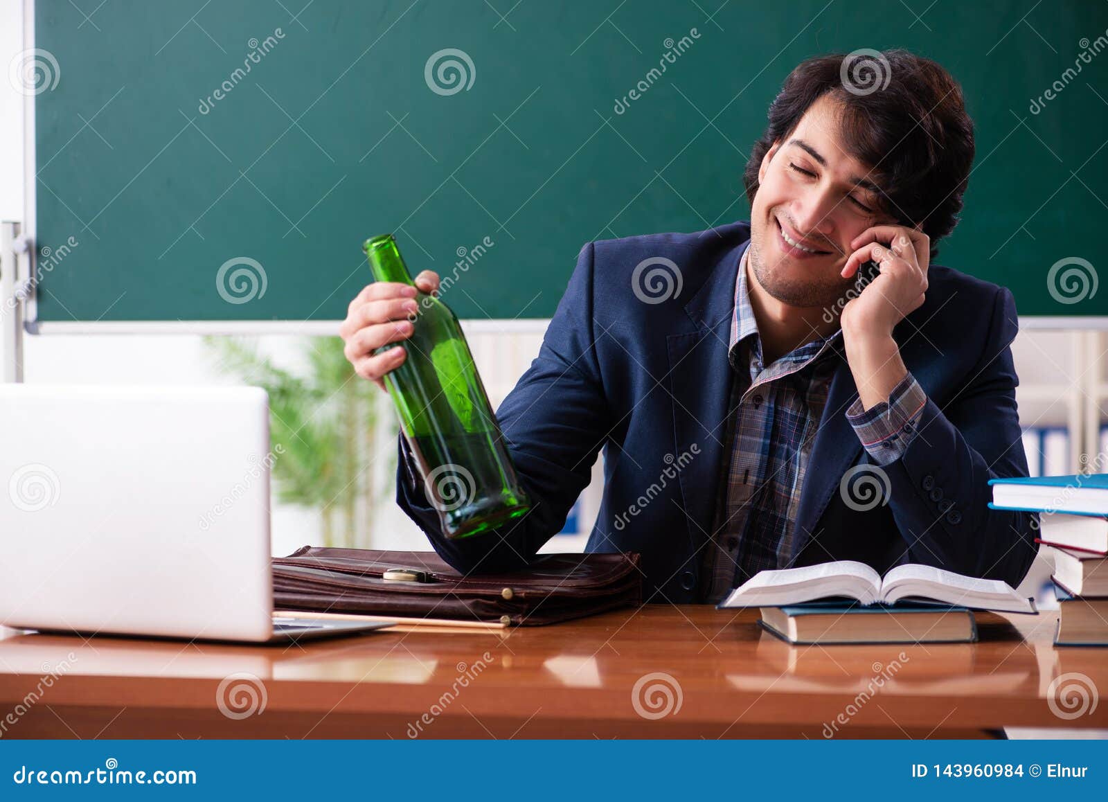 The Male Teacher Drinking in the Classroom Stock Photo - Image of book ...