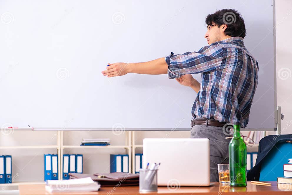 The Male Teacher Drinking in the Classroom Stock Image - Image of ...