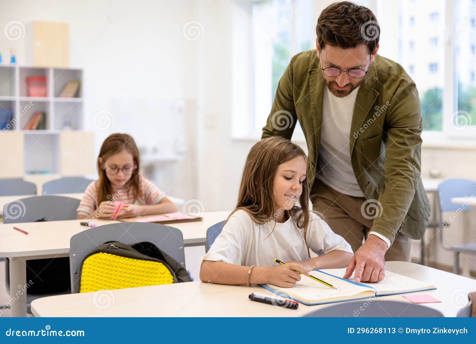 Male Teacher Helping Pupils while Writing the Test Stock Image - Image ...