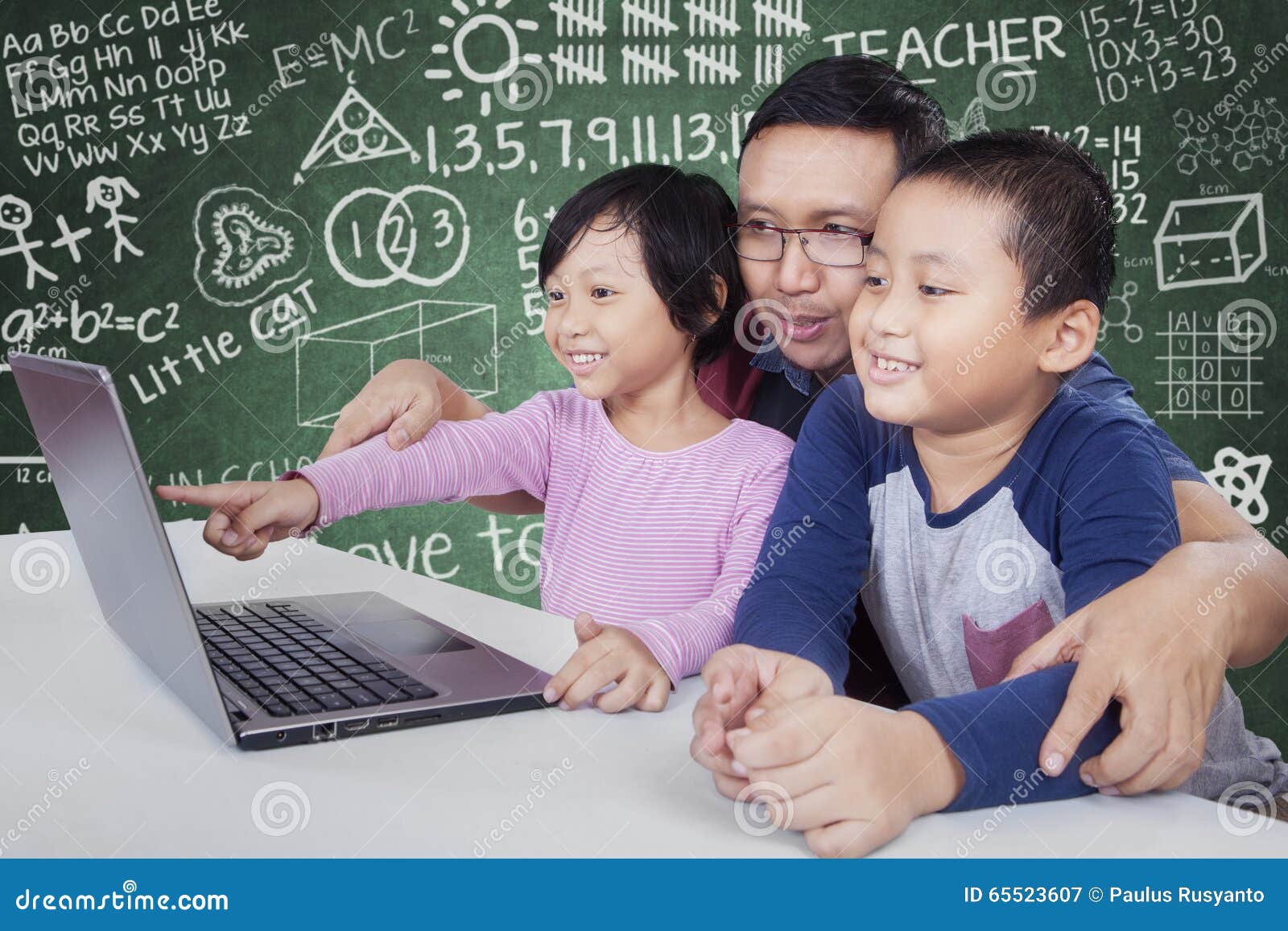 Male Teacher and His Students Using Laptop Stock Image - Image of ...
